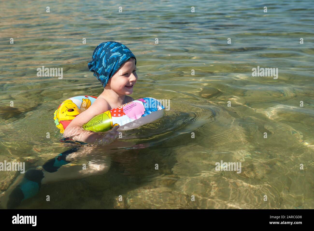 Three year old boy swimming in the sea, Agatha beach, Rhodes, Greece ...