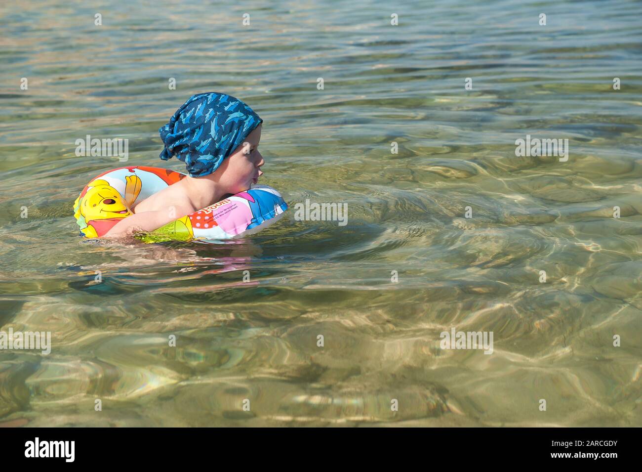 Three year old boy swimming in the sea, Agatha beach, Rhodes, Greece ...