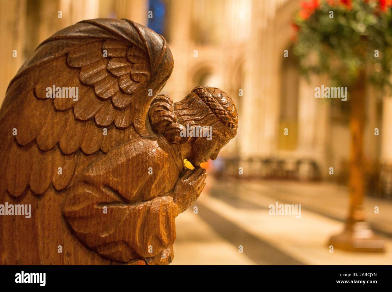 Close Up Shot of Wooden Angle Figure Praying Inside Norwich Cathedral ...