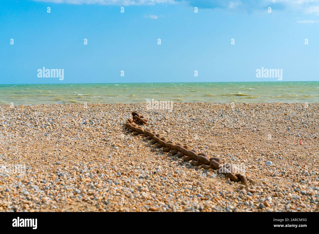 Rye Harbour Nature Reserve length rusty heavy chain left lying on stony ...