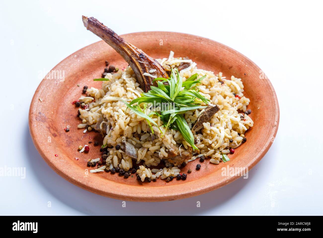 lamb rib with rice on a clay plate. on a white background Stock Photo ...