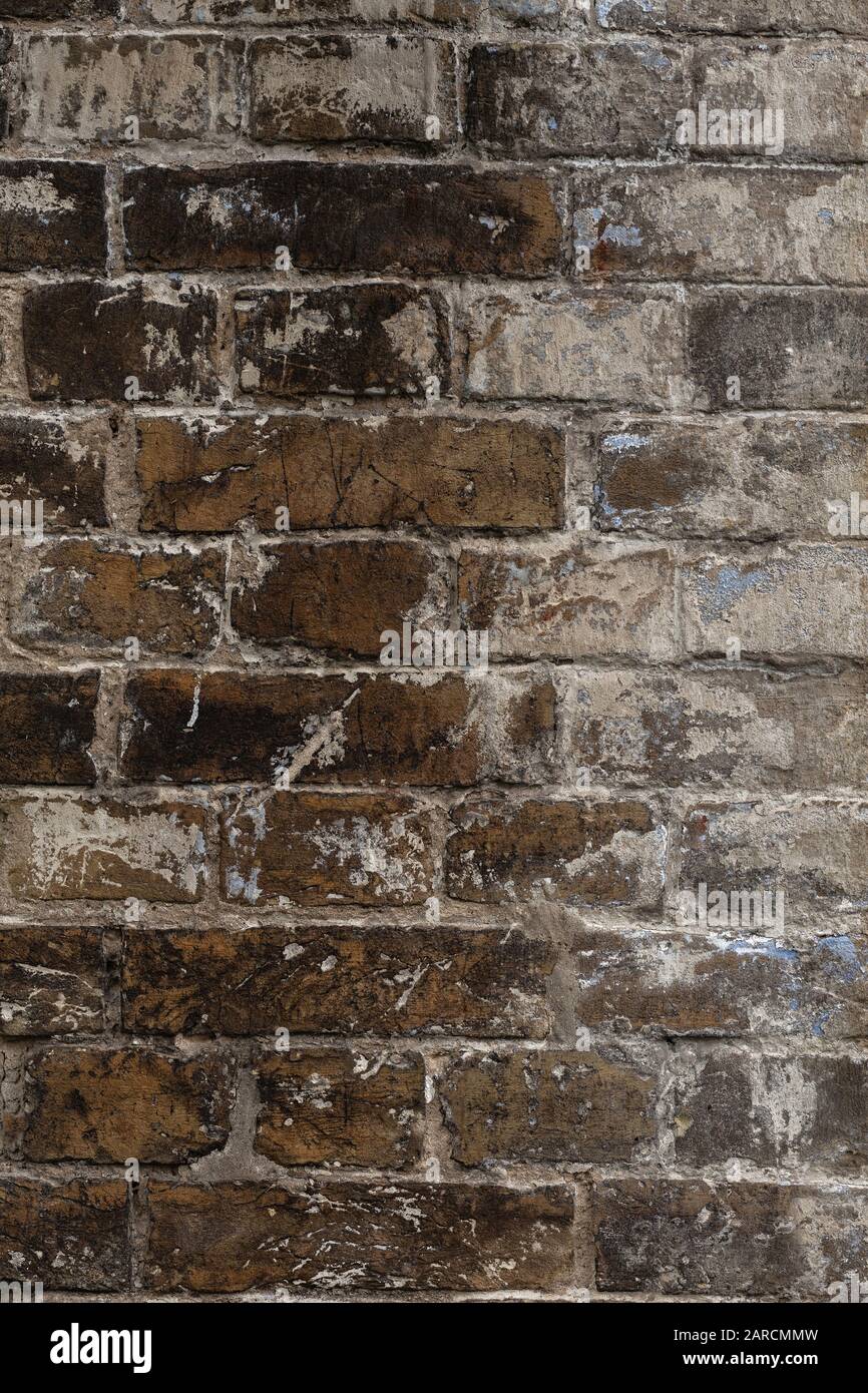 Old vintage shabby brick wall with peeling plaster. Grungy loft texture ...