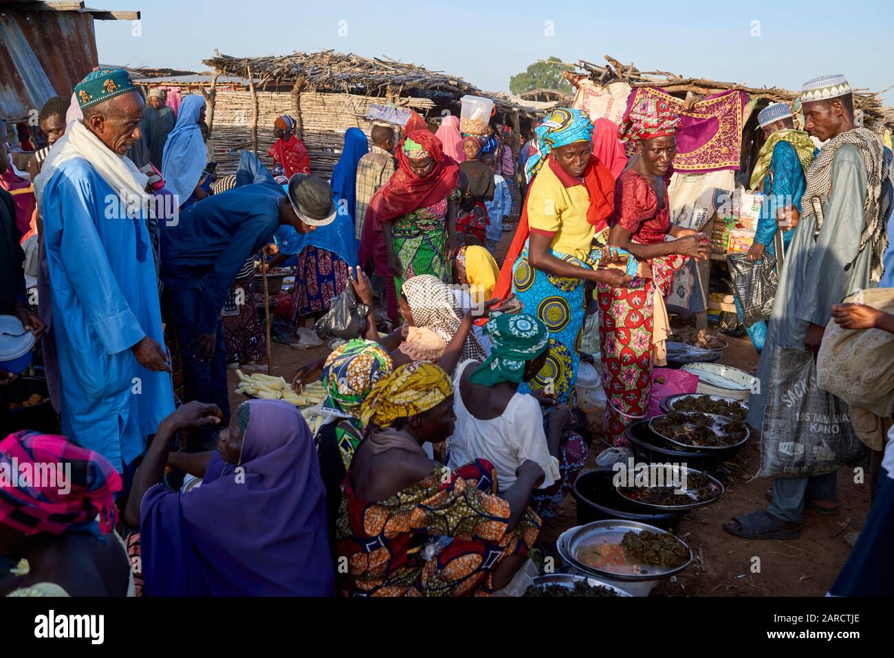 People with colorful dresses selling goods in a local market Stock ...