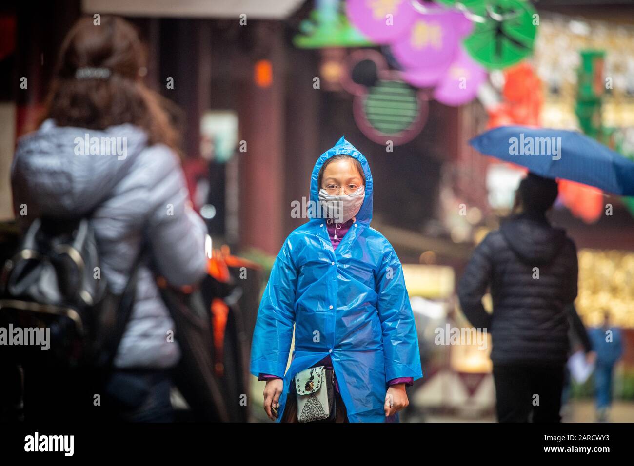 Shanghai, China, 25th Jan 2020, A woman wearing a masks walks down ...