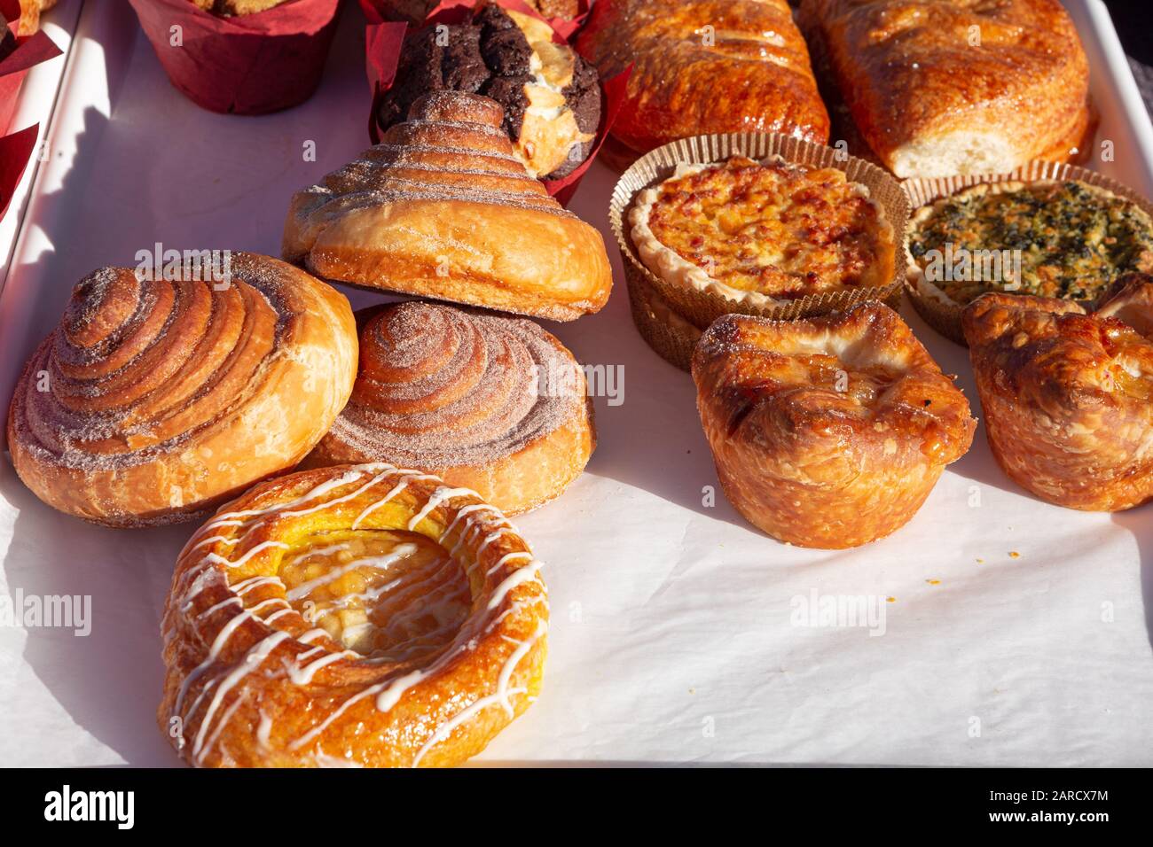 Variety of freshly baked pastries for sale at an outdoor market Stock ...