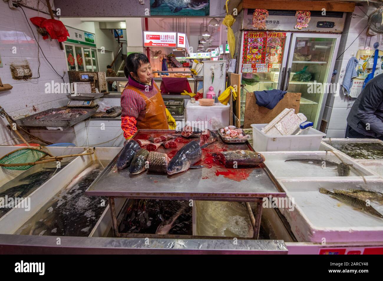 Shanghai, China, 26th Jan 2020, A women store merchant stands behind ...