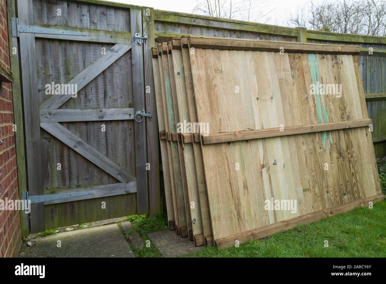 Replacement fence panels with vertical slats stacked waiting for ...