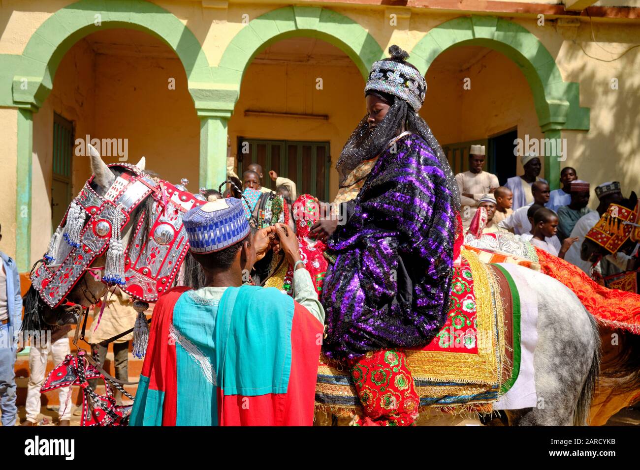 Nobleman rider dressed in a colourful outfit mounting an embellished ...