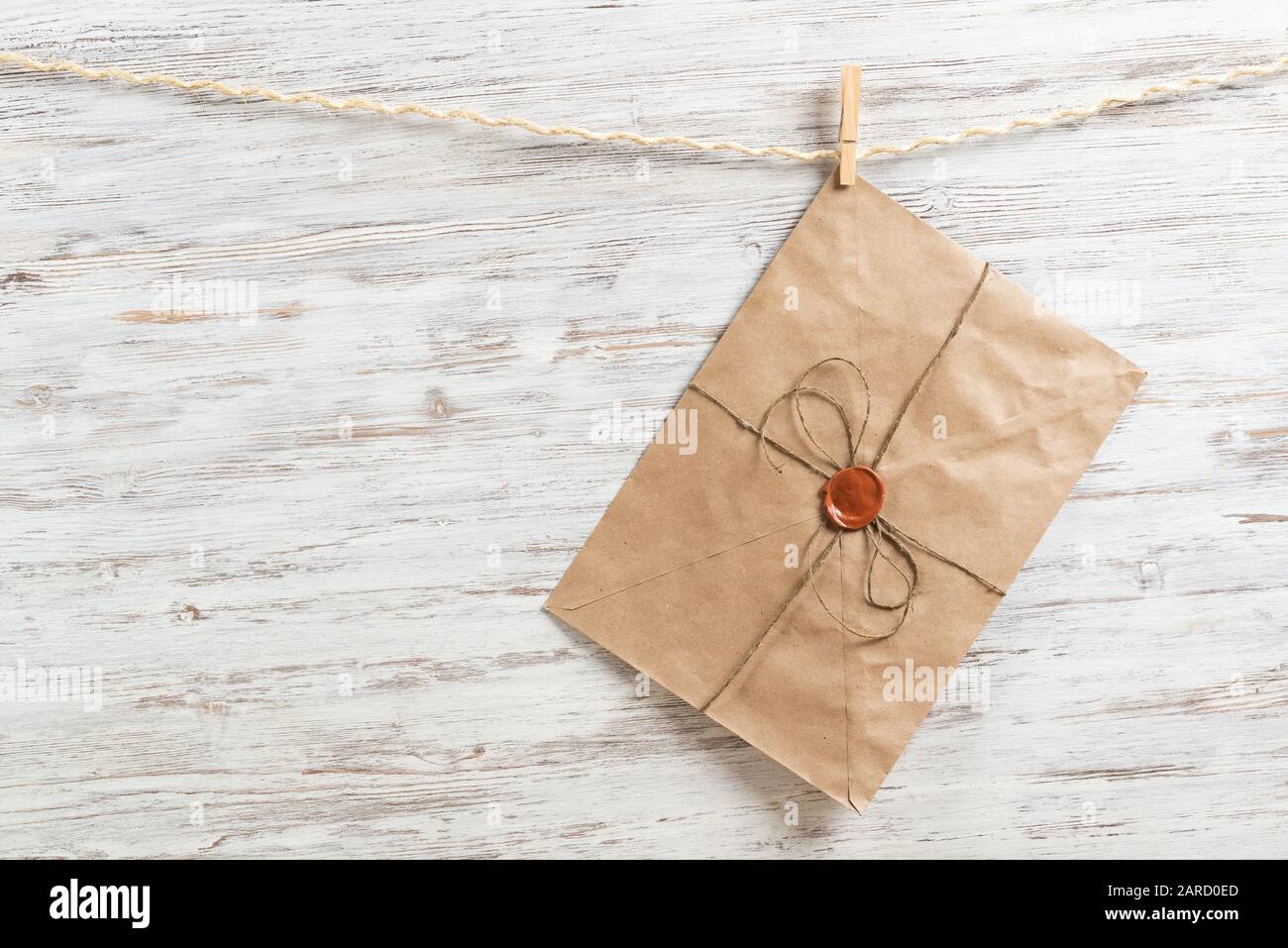Old paper envelope hanging on rope Stock Photo - Alamy