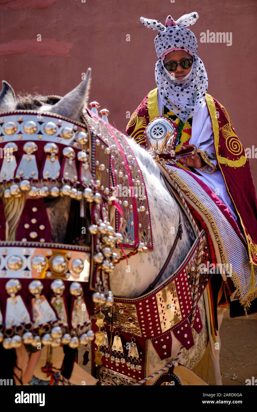 Nobleman rider dressed in a colourful outfit mounting an embellished ...