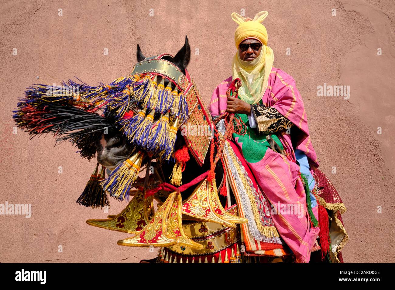 Nobleman rider dressed in a colourful outfit mounting an embellished ...