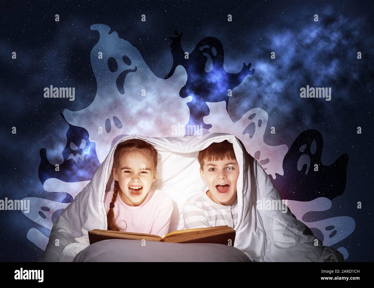 Happy little kids reading book in bed Stock Photo - Alamy