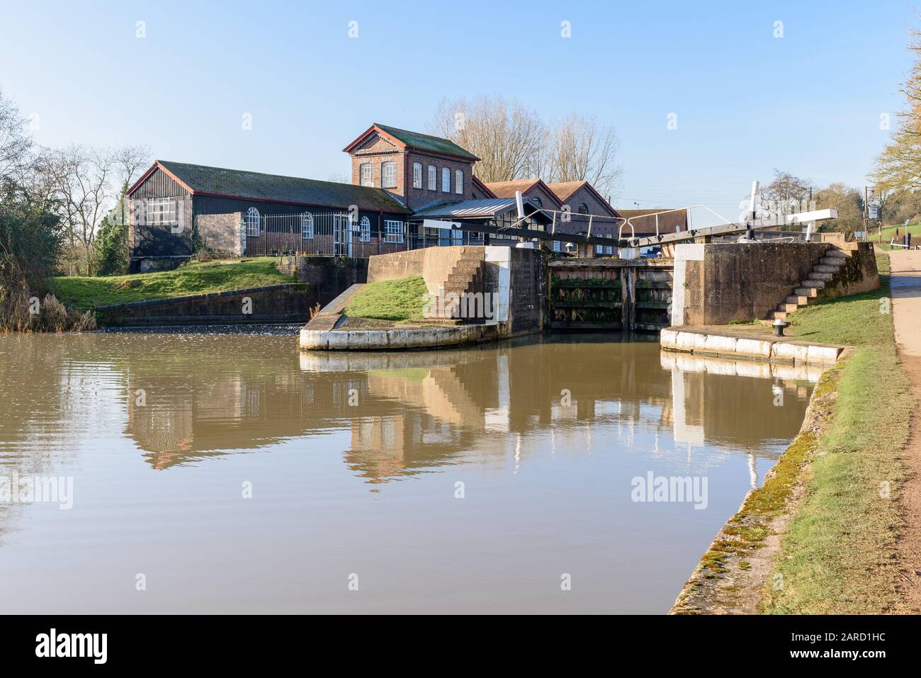 A building at Hatton Locks, in winter, with a blue sky and reflections ...
