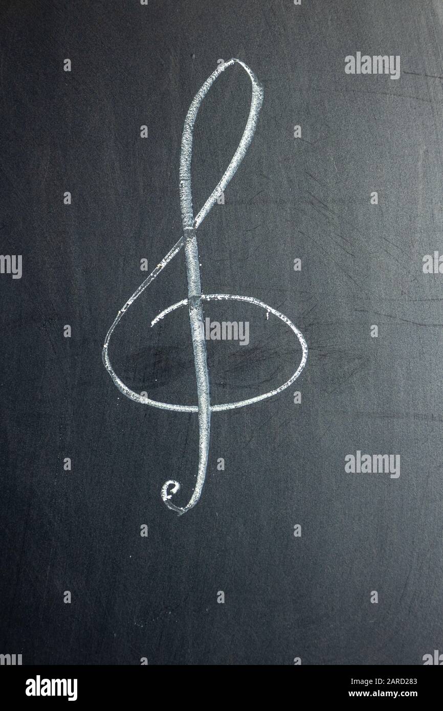 Treble clef on a black chalk board Stock Photo - Alamy