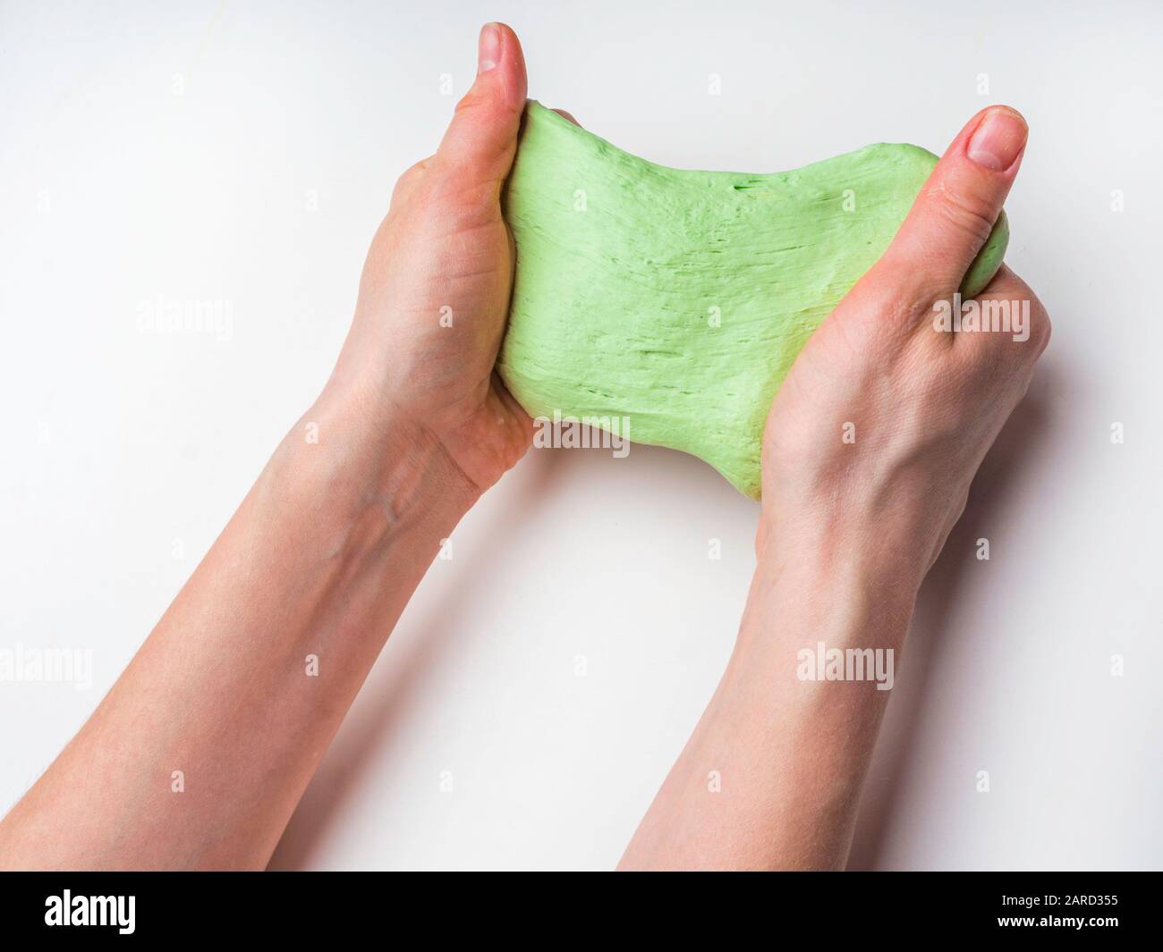 Sticky slime in the hand. The green slime in hands. Favorite toy for a ...