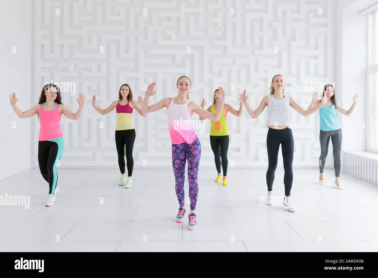 Young women in colorful sportswear at dance fitness class in fitness ...