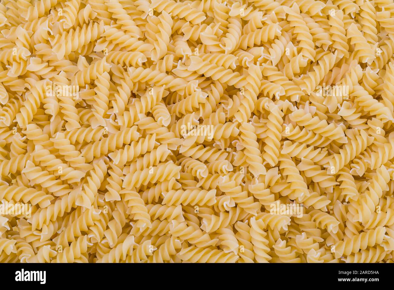 Raw dried extruded fusilli pasta texture. Staple food of Italian ...
