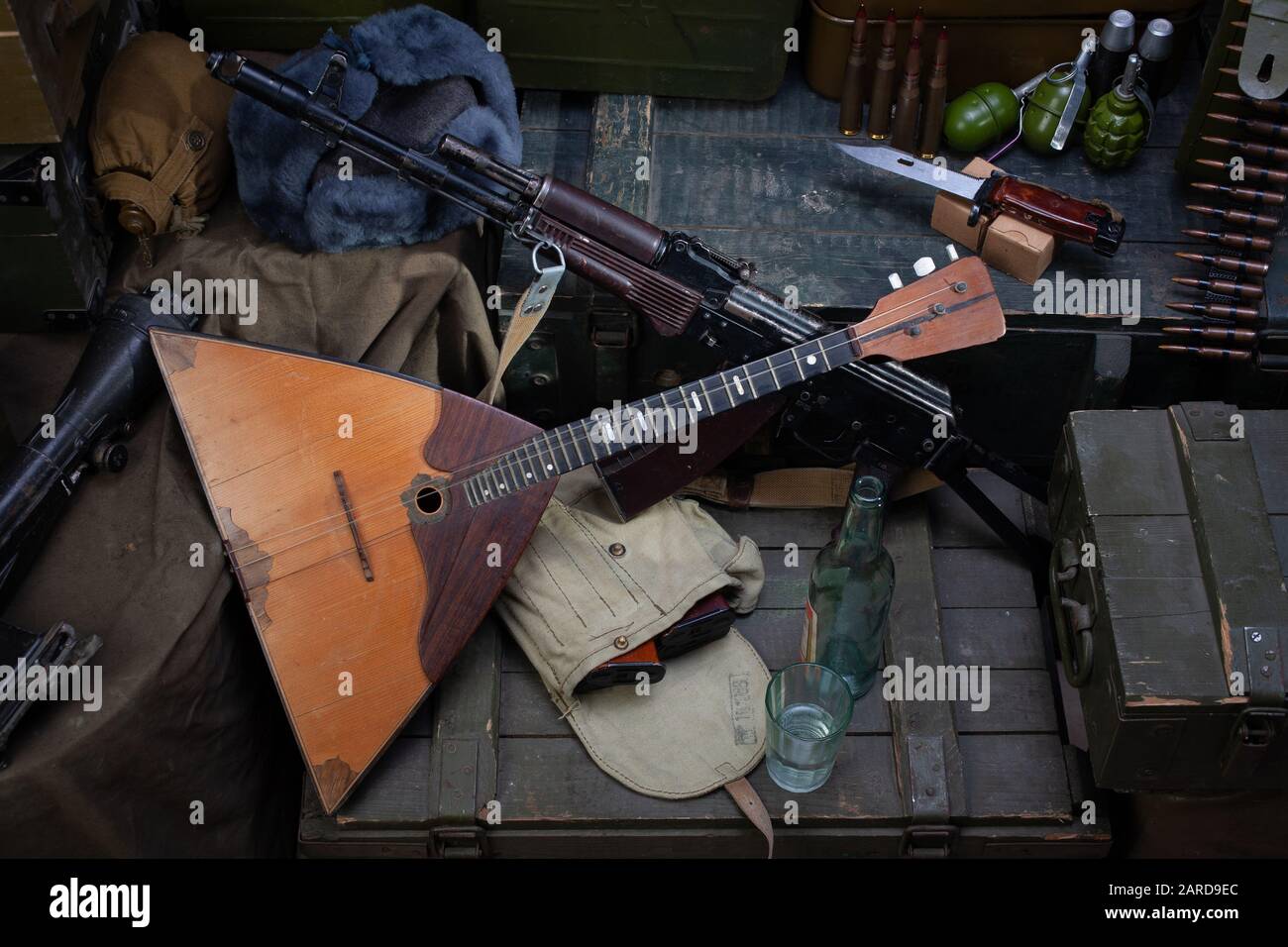 Kalashnikov AK 47 with ammunitions and vodka on green army box ...