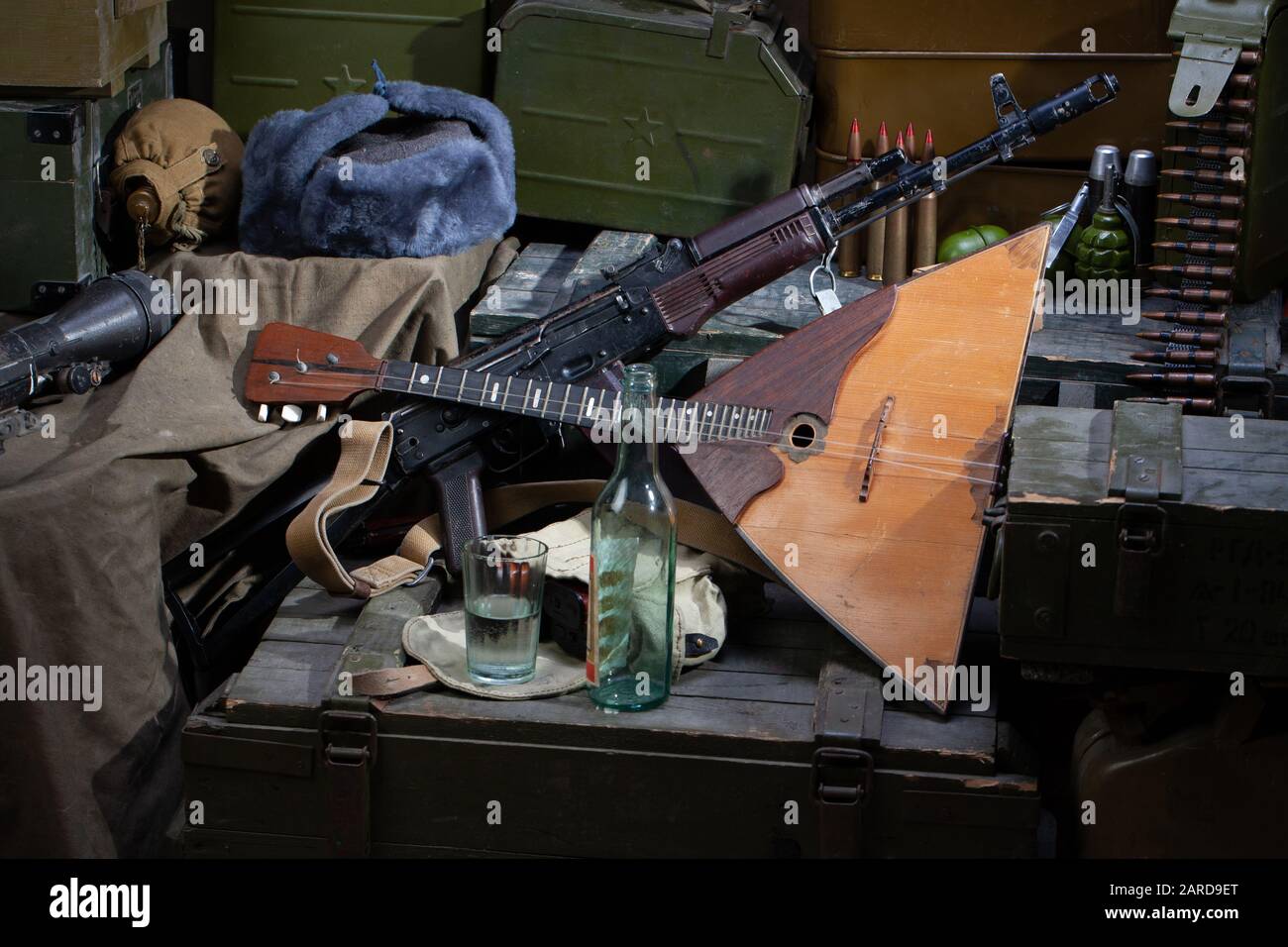 Kalashnikov AK 47 with ammunitions and vodka on green army box ...