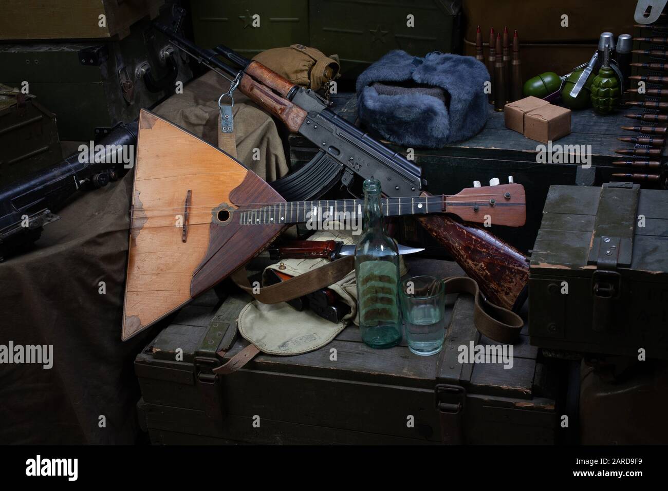 Kalashnikov AK 47 with ammunitions and vodka on green army box ...