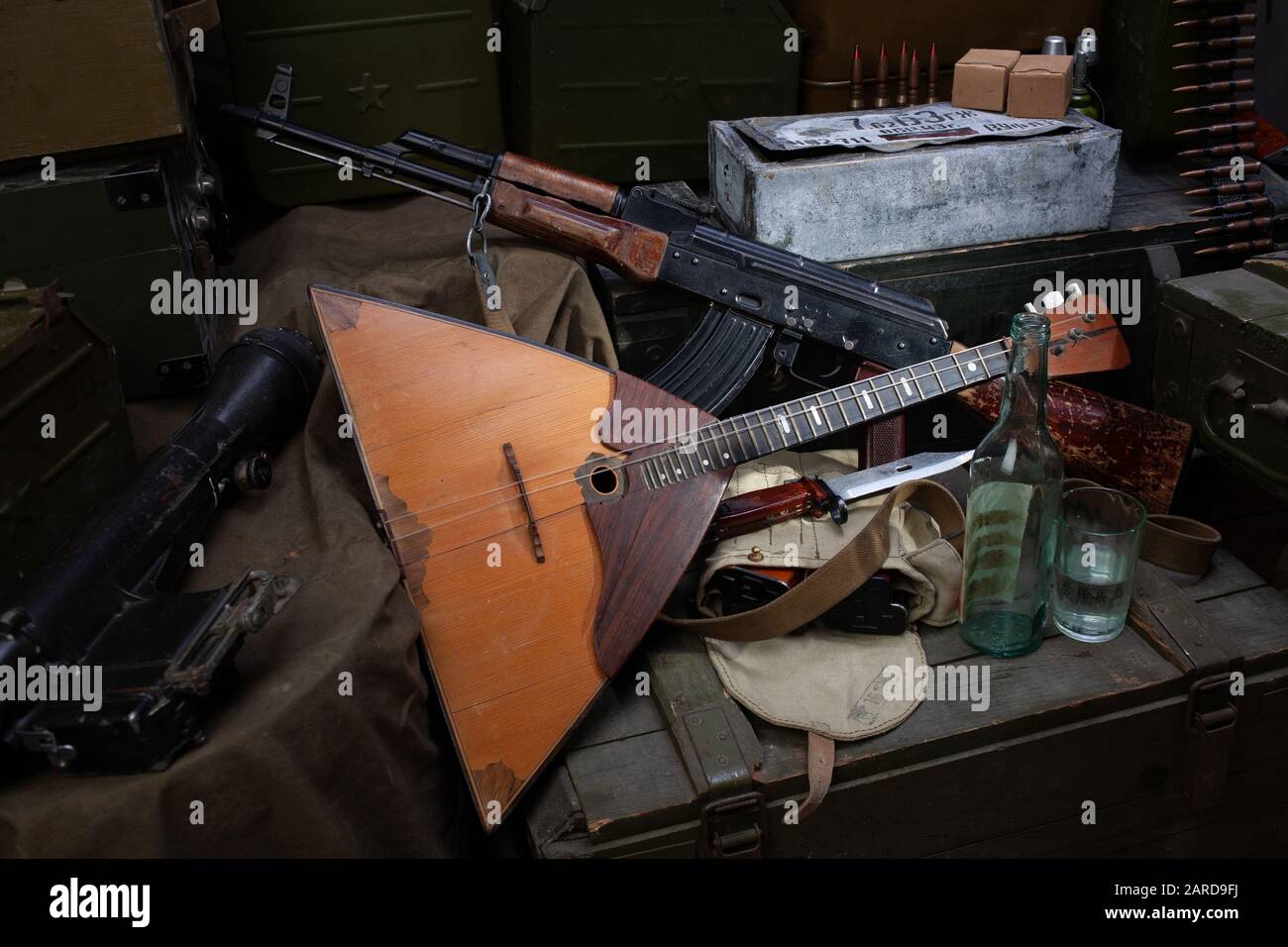 Kalashnikov AK 47 with ammunitions and vodka on green army box ...