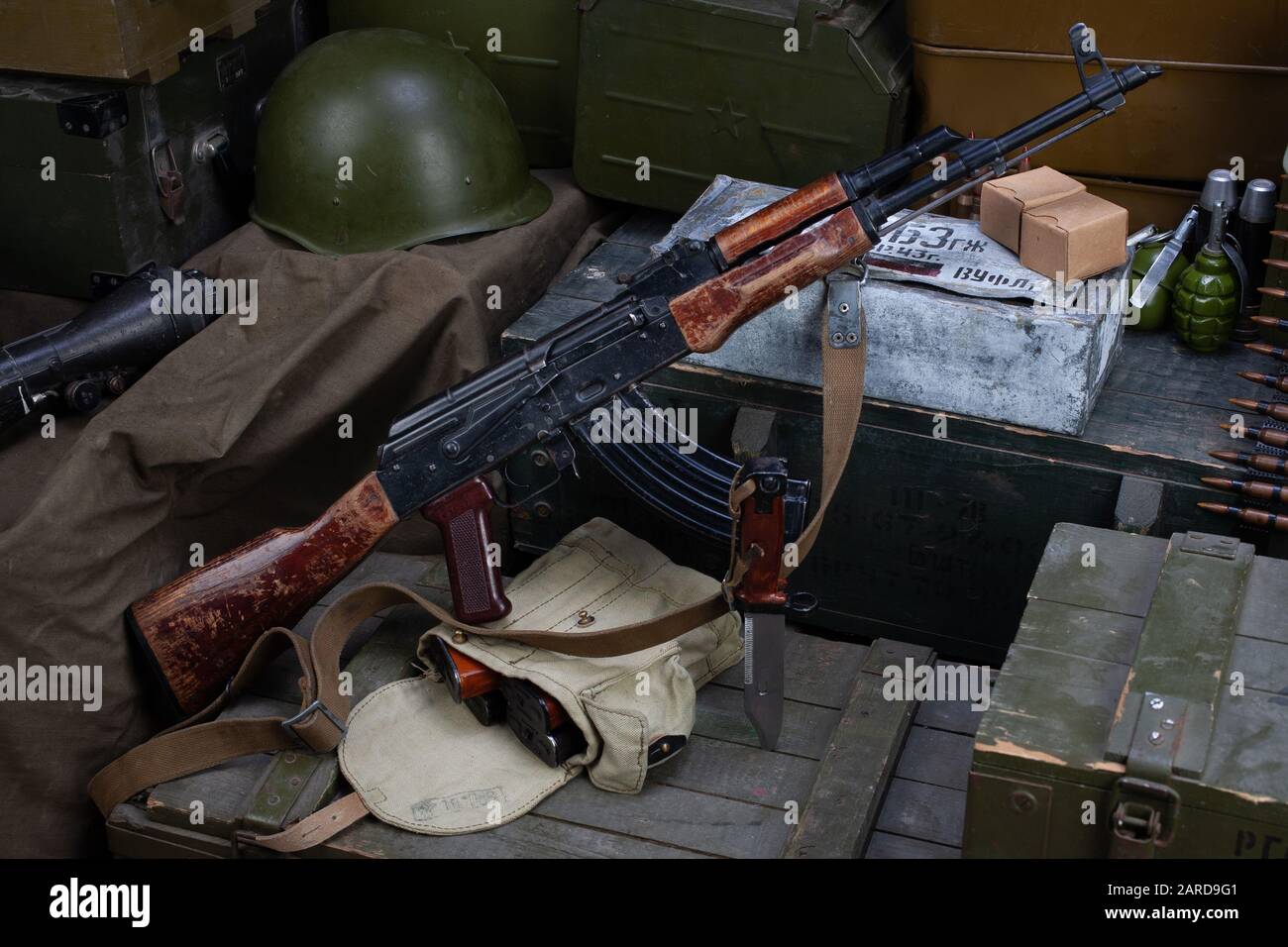Kalashnikov AK 47 with ammunitions on army green box background. Text ...