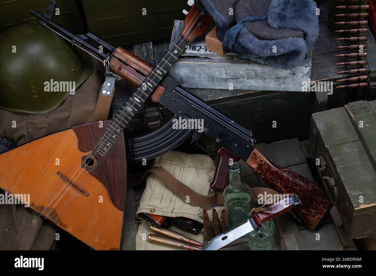 Kalashnikov AK 47 with ammunitions and vodka on green army box ...