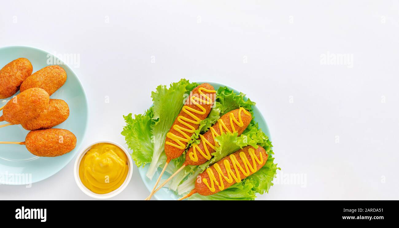 American junk food. Corn dogs on white background. Copy space, top view ...