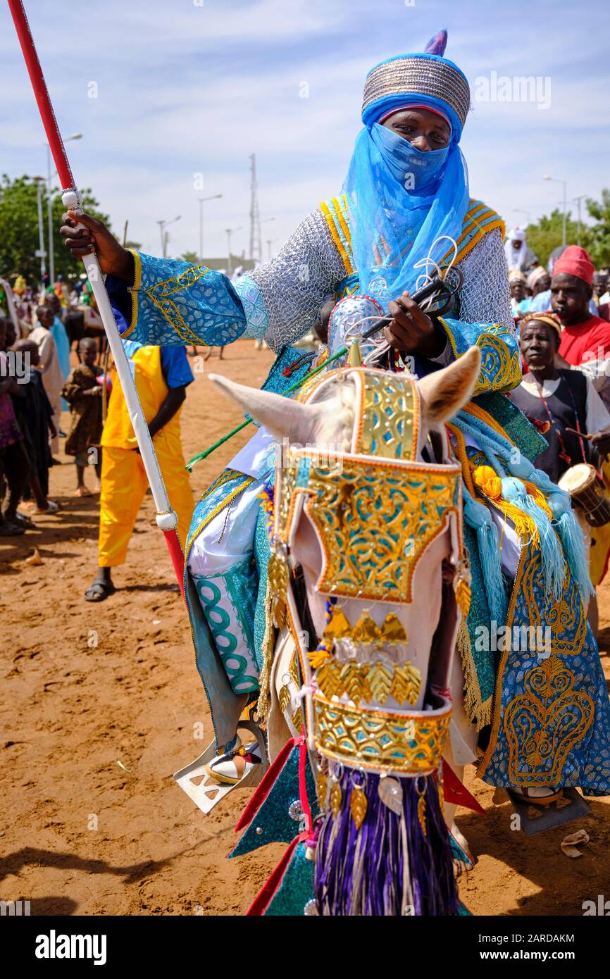 Nobleman rider dressed in a colourful outfit mounting an embellished ...
