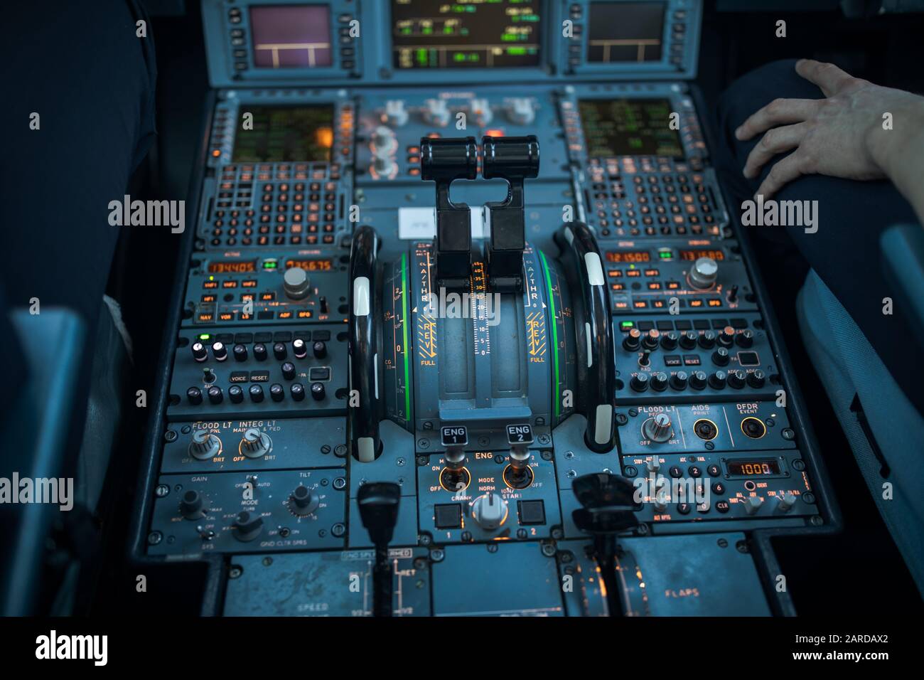 Pilot's hand accelerating on the throttle in a commercial airliner ...