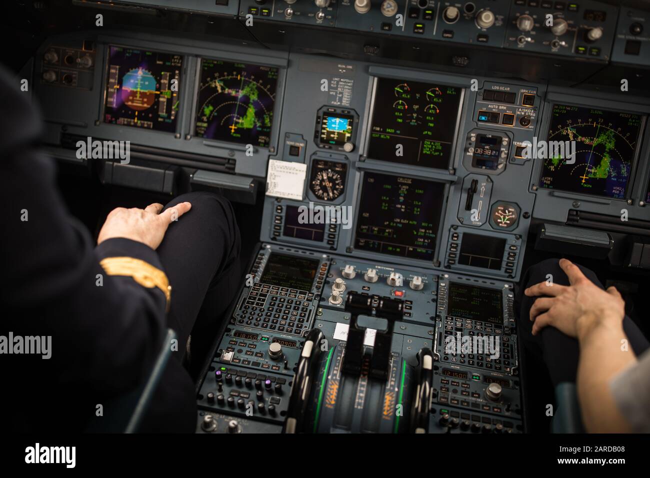 Pilot's hand accelerating on the throttle in a commercial airliner ...