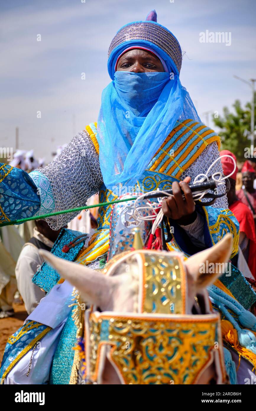 Nobleman rider dressed in a colourful outfit mounting an embellished ...