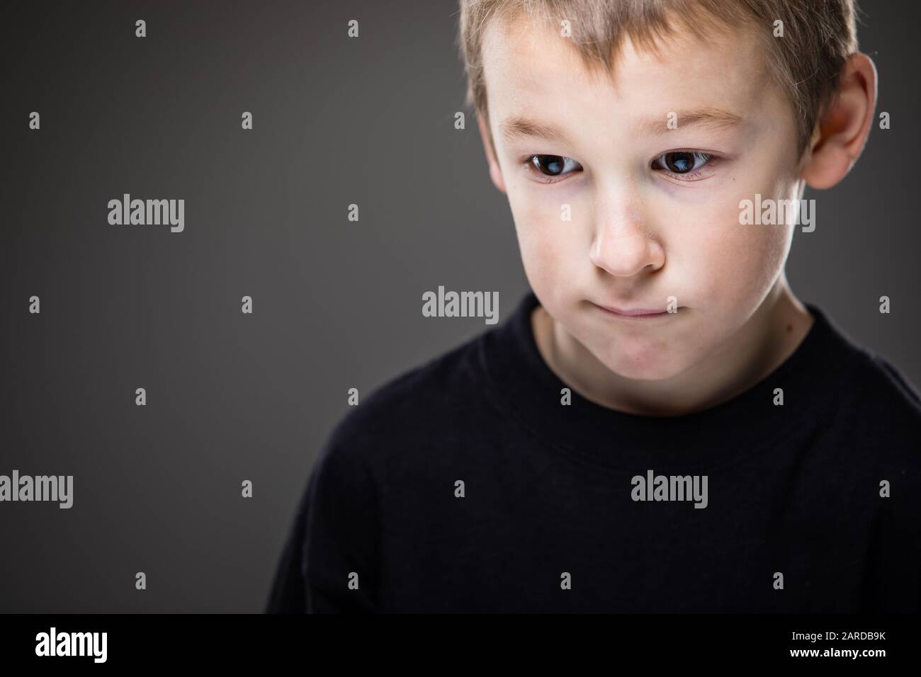 Grief-stricken little boy - feeling intense sorrow, remorse, sadnesss ...