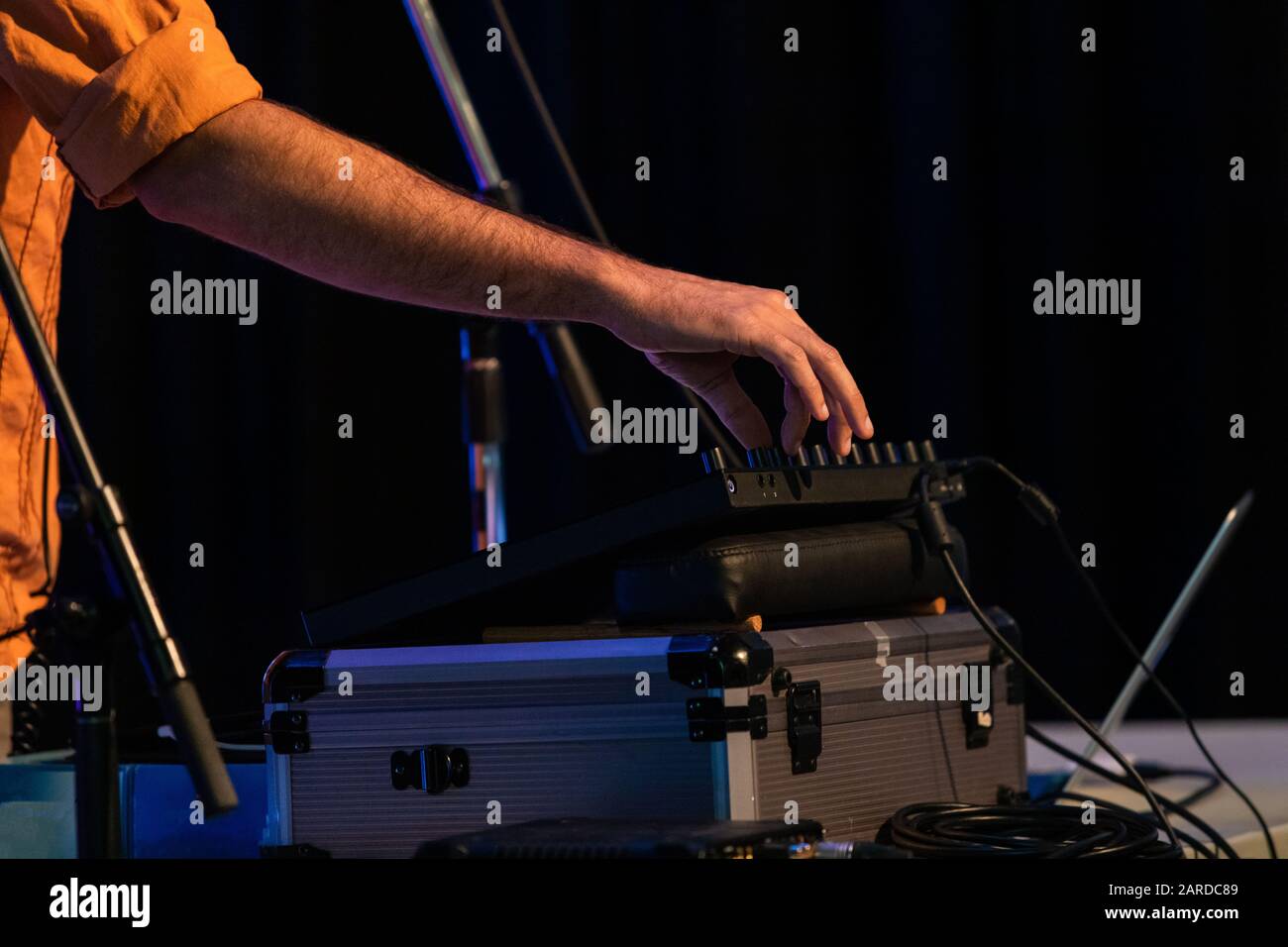 Closeup of man's hand controlling sound using digital mixing control ...