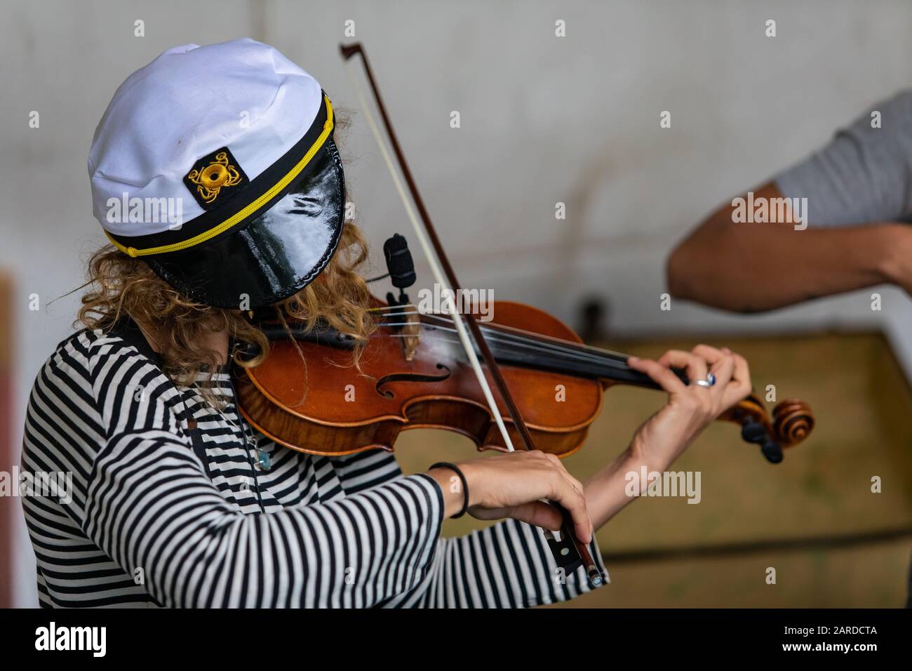 Closeup of female artist wearing stripped t-shirt and white policeman ...
