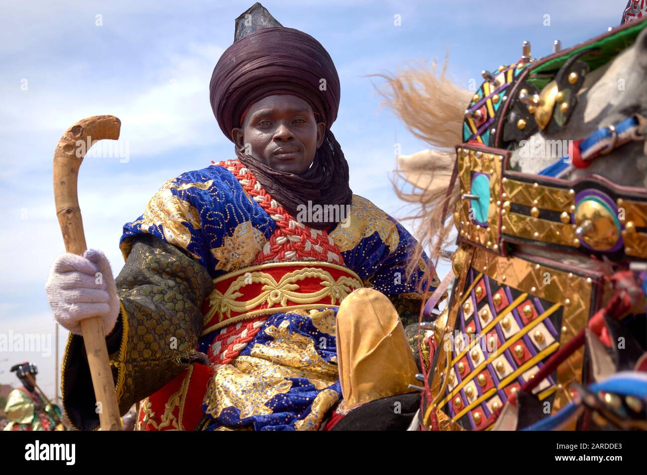 Nobleman rider dressed in a colourful outfit mounting an embellished ...