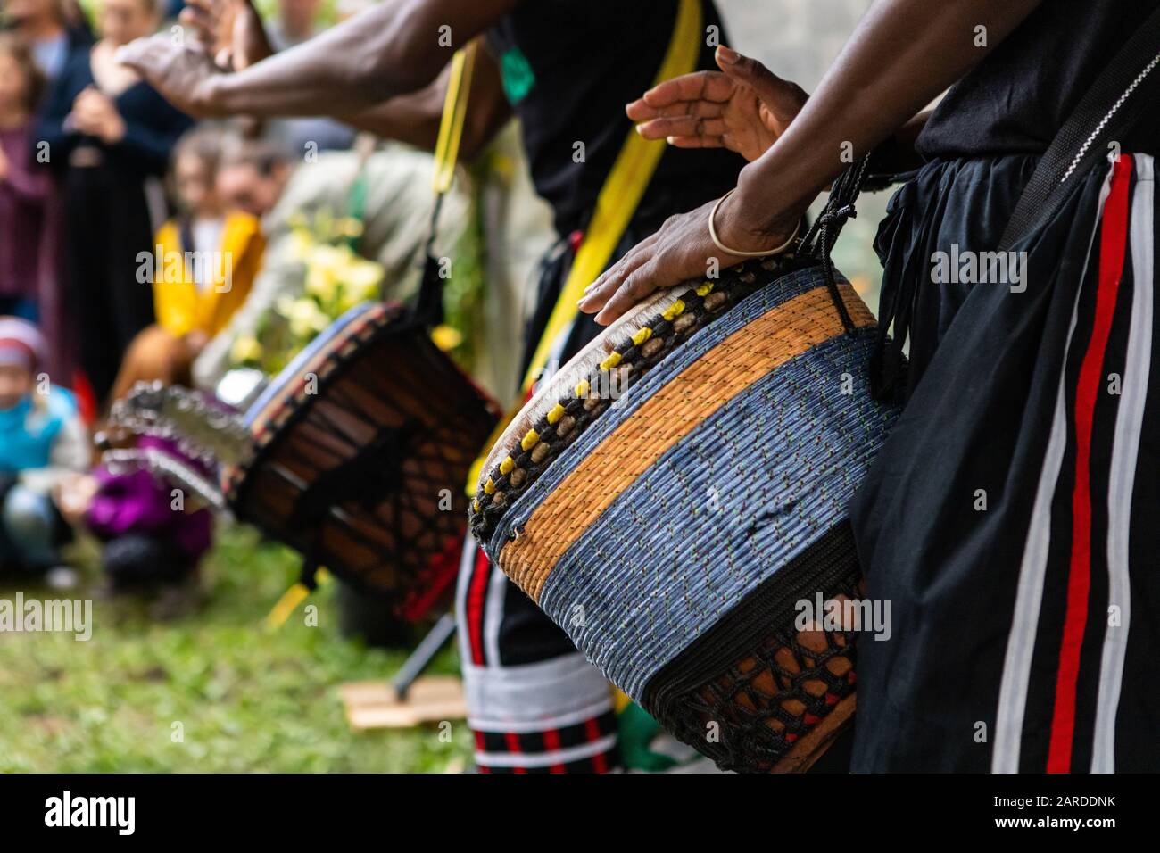 Closeup midsection of two artist performing traditional colorful string ...