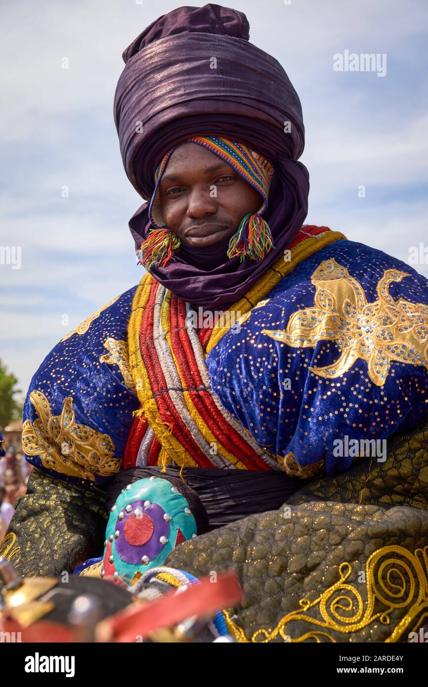 Nobleman rider dressed in a colourful outfit mounting an embellished ...