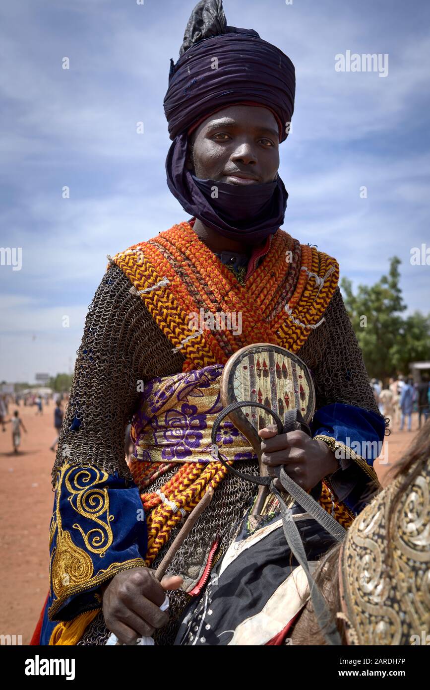 Nobleman rider dressed in a colourful outfit mounting an embellished ...