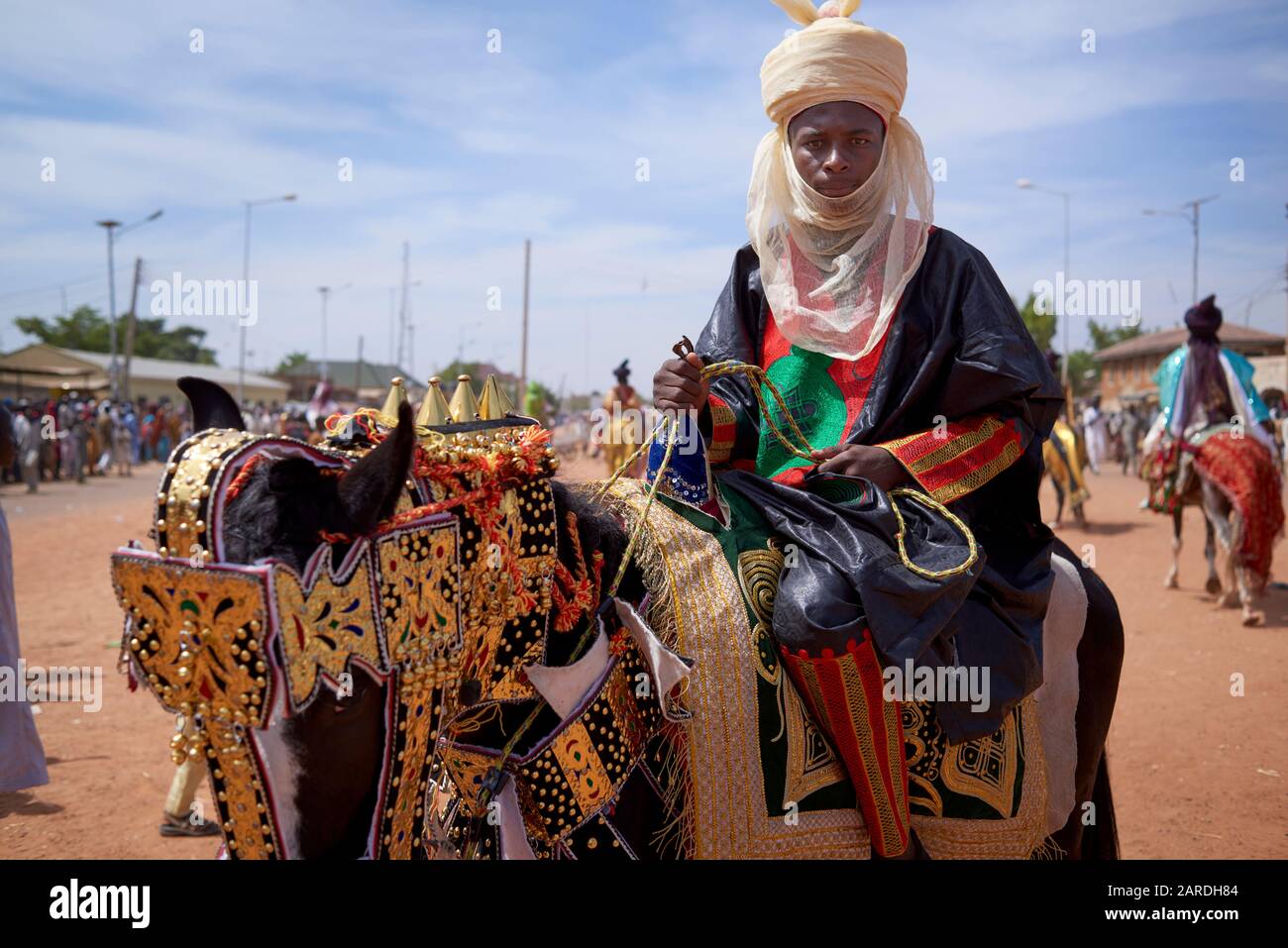 Nobleman rider dressed in a colourful outfit mounting an embellished ...