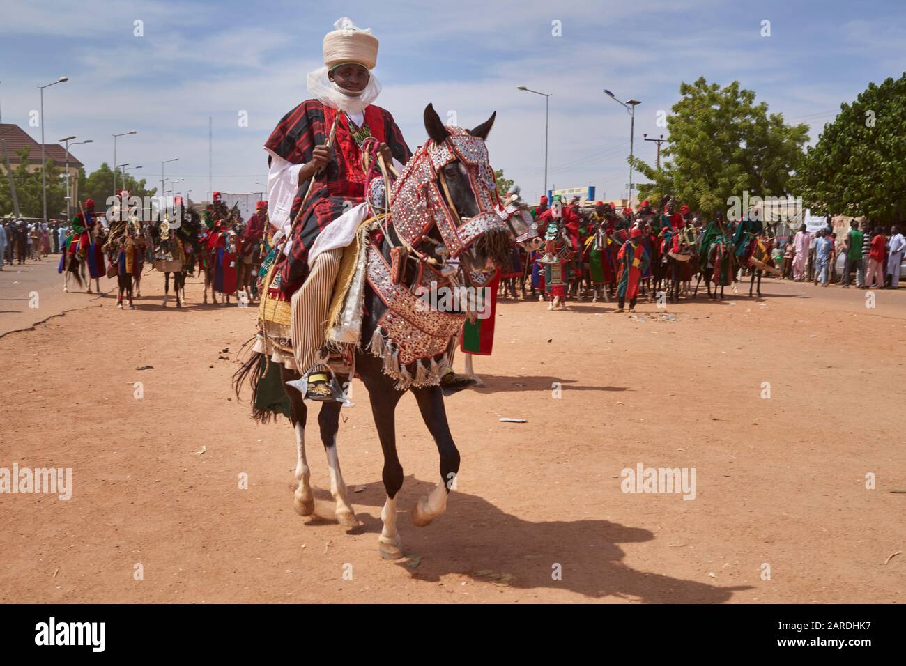 Nobleman rider dressed in a colourful outfit mounting an embellished ...