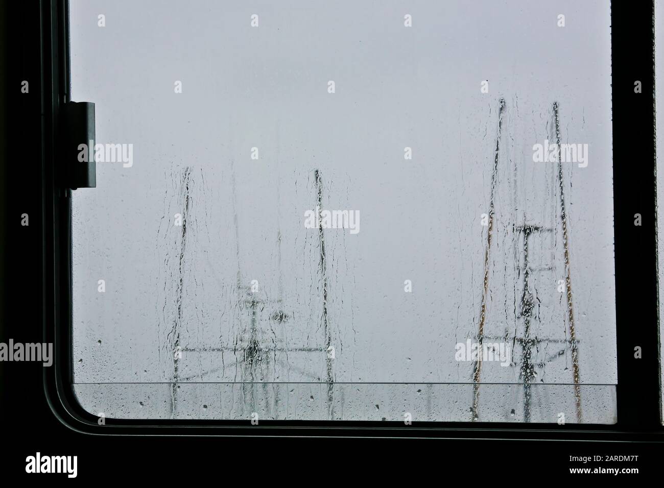 Fishing boats in Pelican Harbor, AK seen through rain-splattered window ...