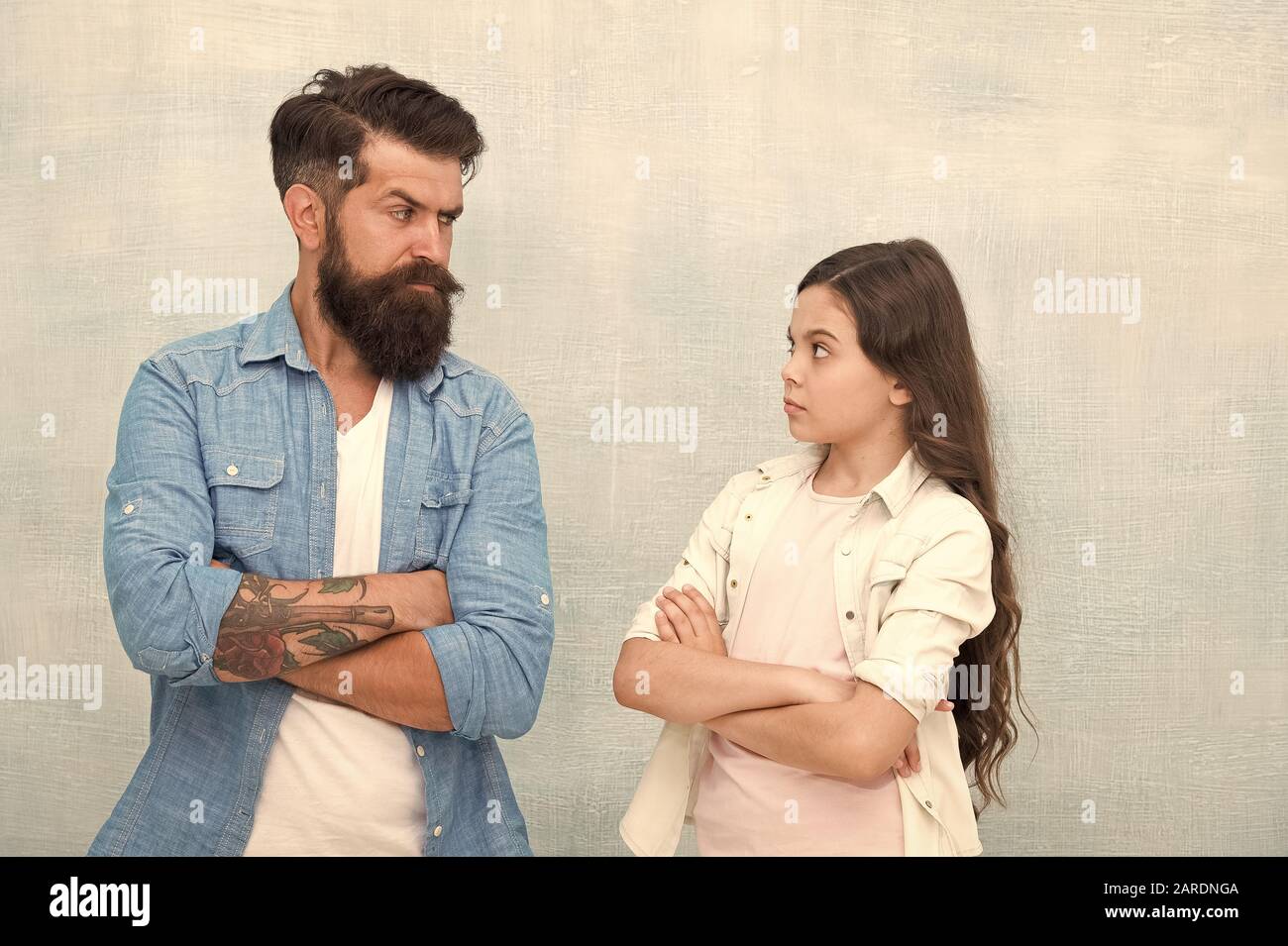 Family conflict. Bearded hipster man and child girl. Confrontation concept. Frowning man and ...