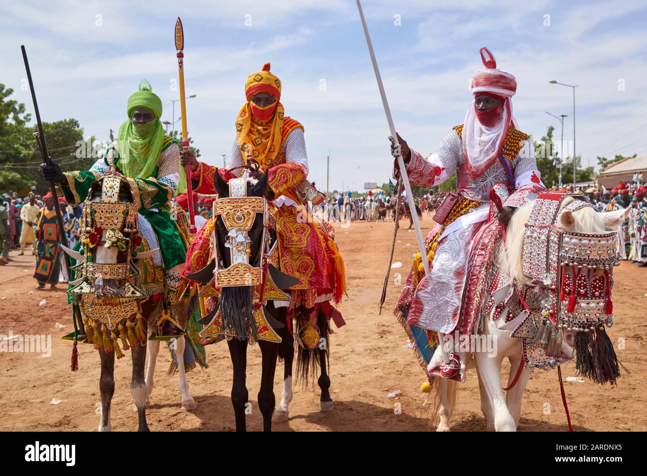 Noblemen riders dressed in a colourful outfit mounting embellished ...