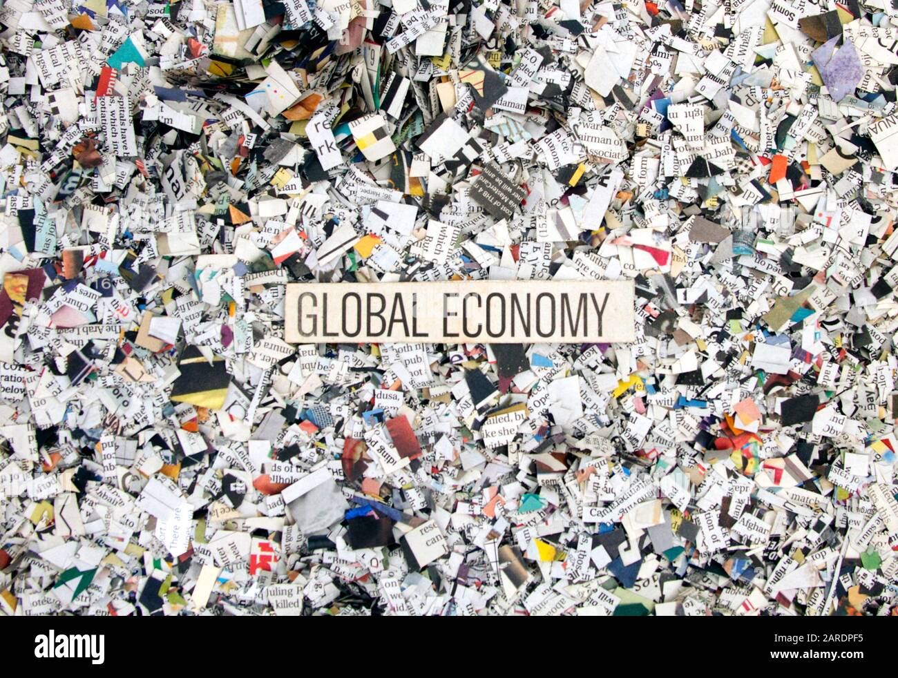 Newspaper confetti from above with the word GLOBAL ECONOMY background ...