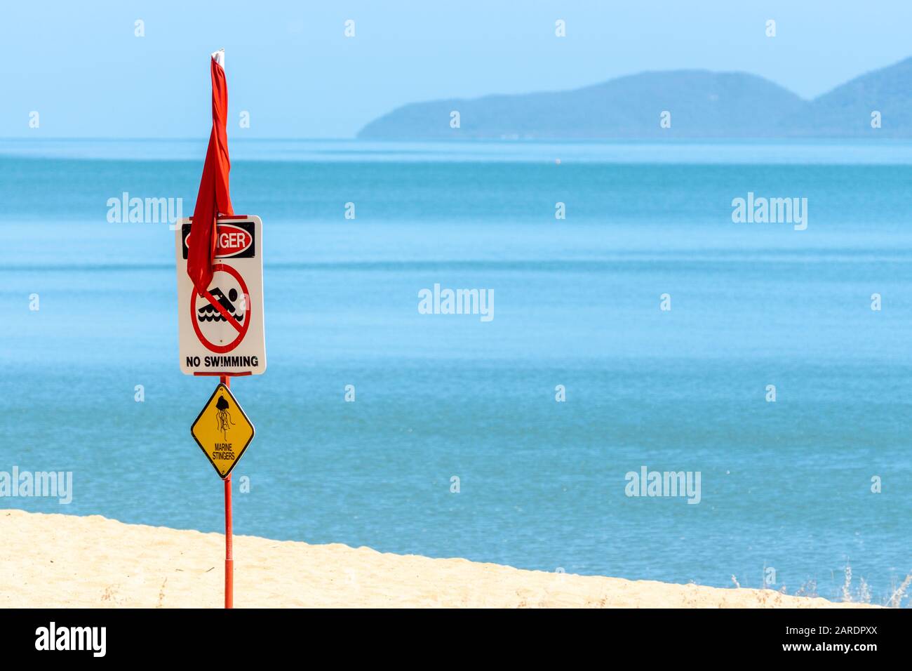 Warning sign for marine stingers on sandy beach at the Strand ...