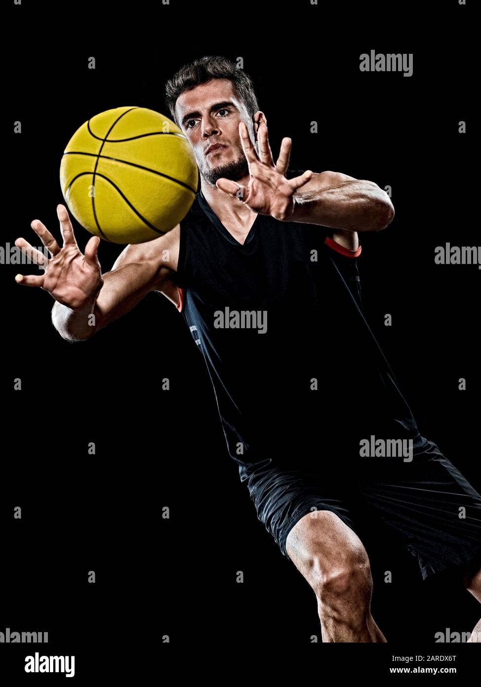 one caucasian young basketball player man in studio isolated on black ...