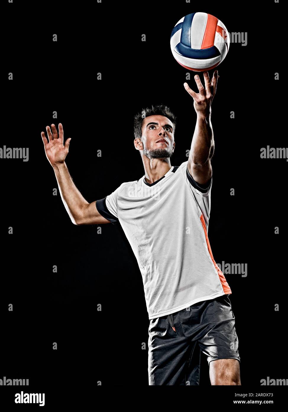 one caucasian young volley ball player man in studio isolated on black ...