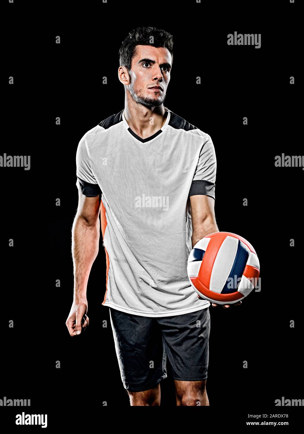 one caucasian young volley ball player man in studio isolated on black ...