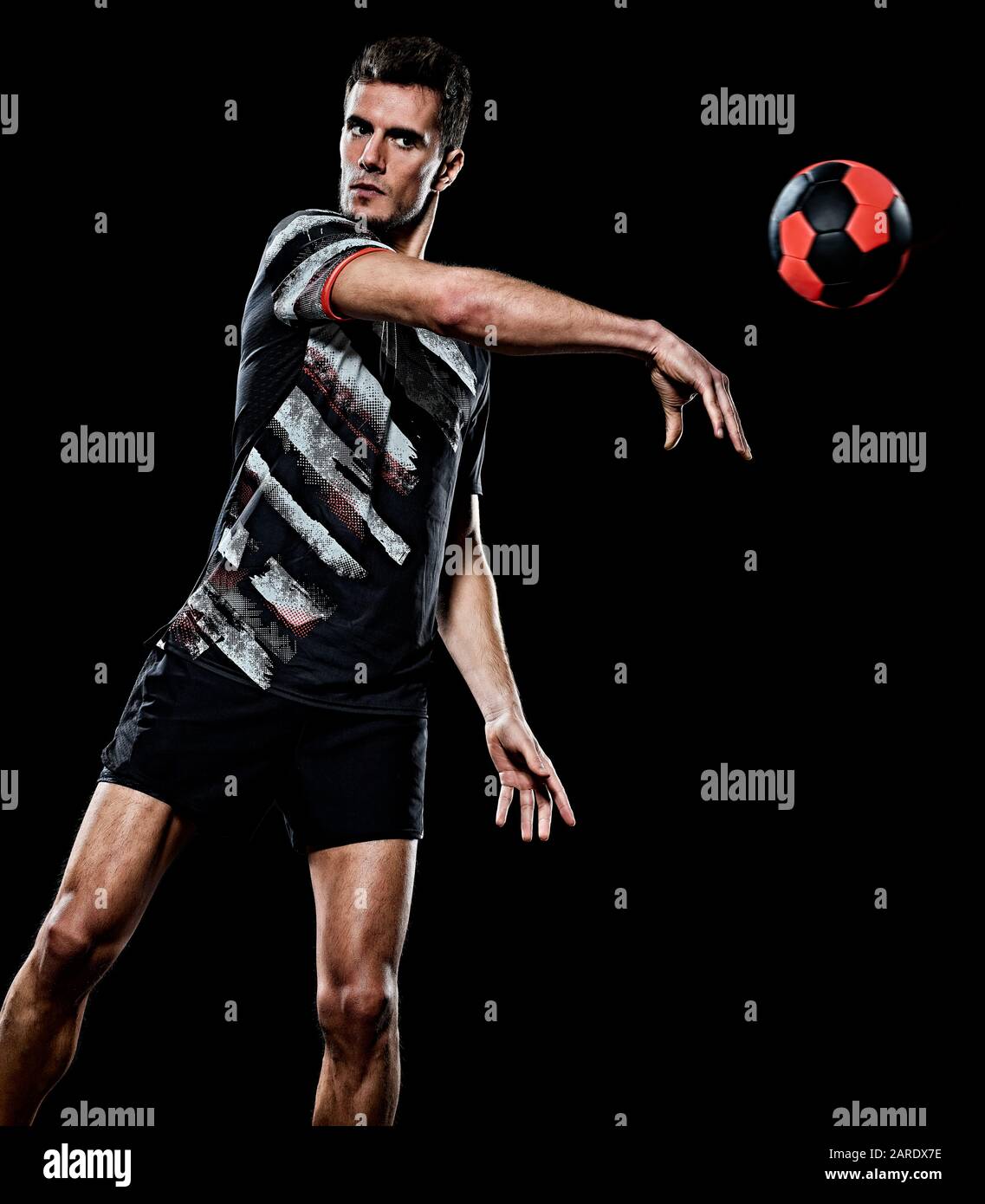 one caucasian young handball player man in studio isolated on black ...